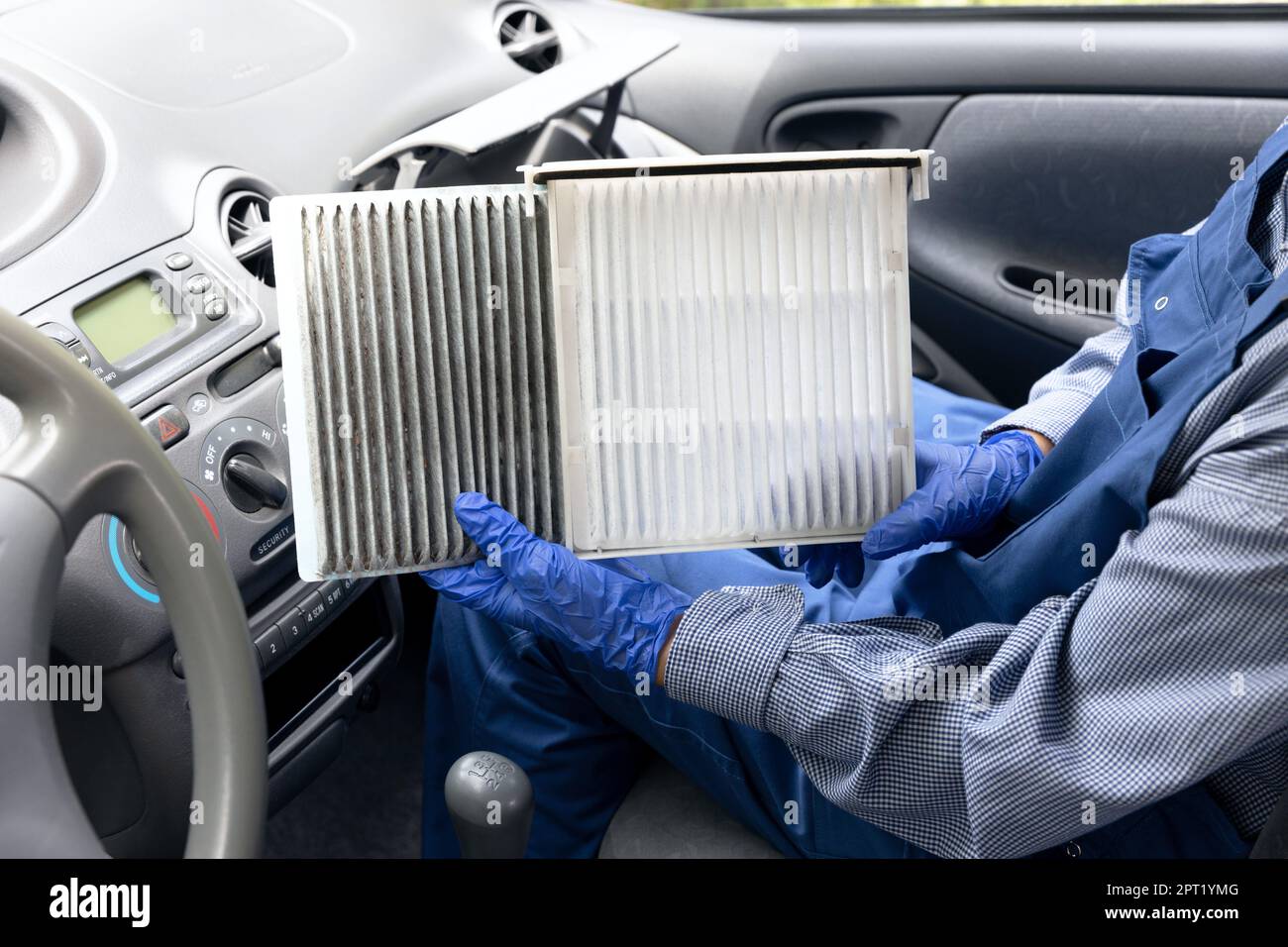 Replacing the cabin pollen air filter for a car Stock Photo - Alamy