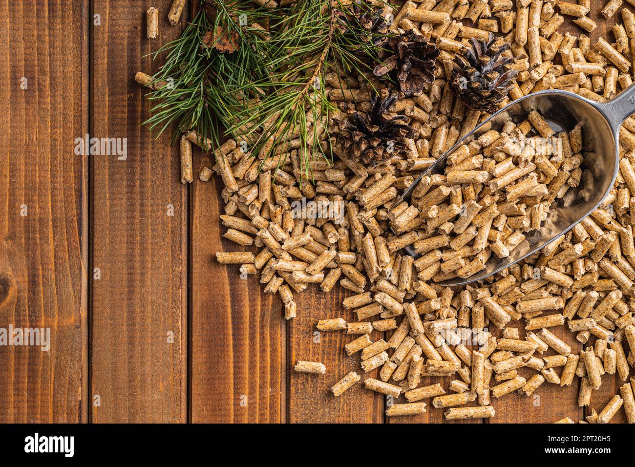 Wooden pellets in scoop on the wooden table. Top view Stock Photo - Alamy