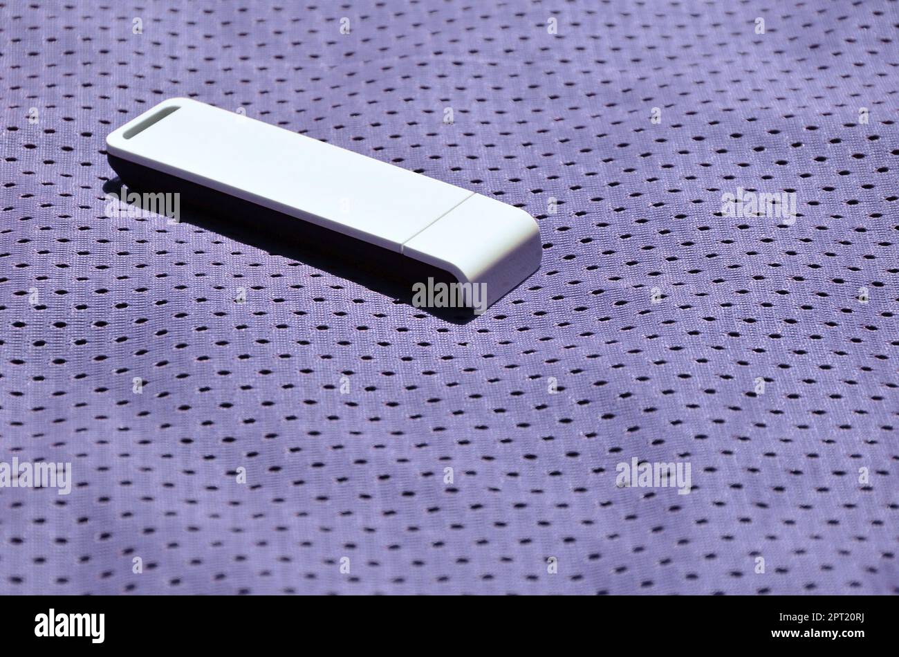 A modern portable USB wi-fi adapter is placed on the violet sportswear ... A modern portable USB wi-fi adapter is placed on the violet sportswear ...