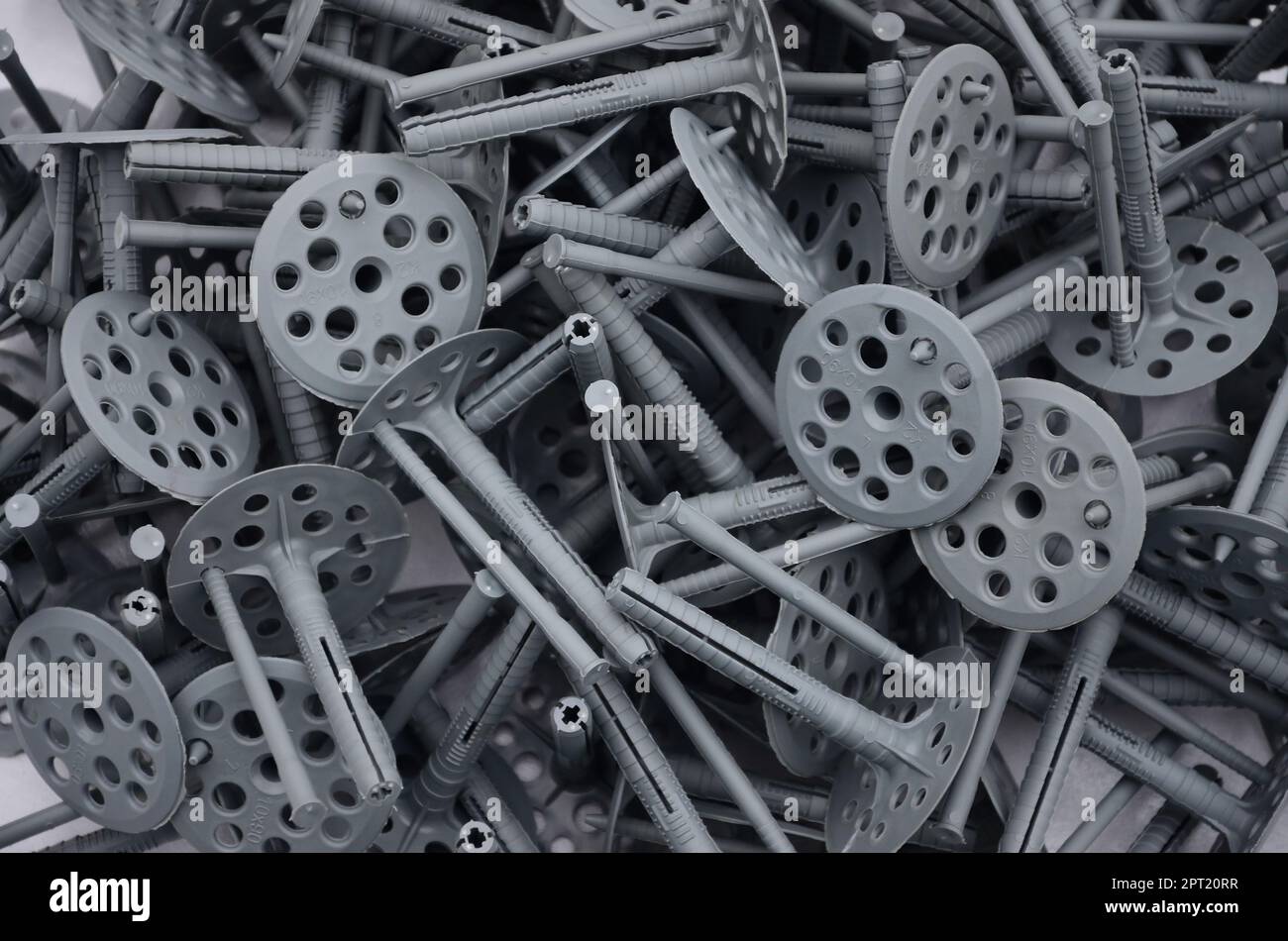 Background pattern of many gray plastic dowels (fastening) for thermal ...
