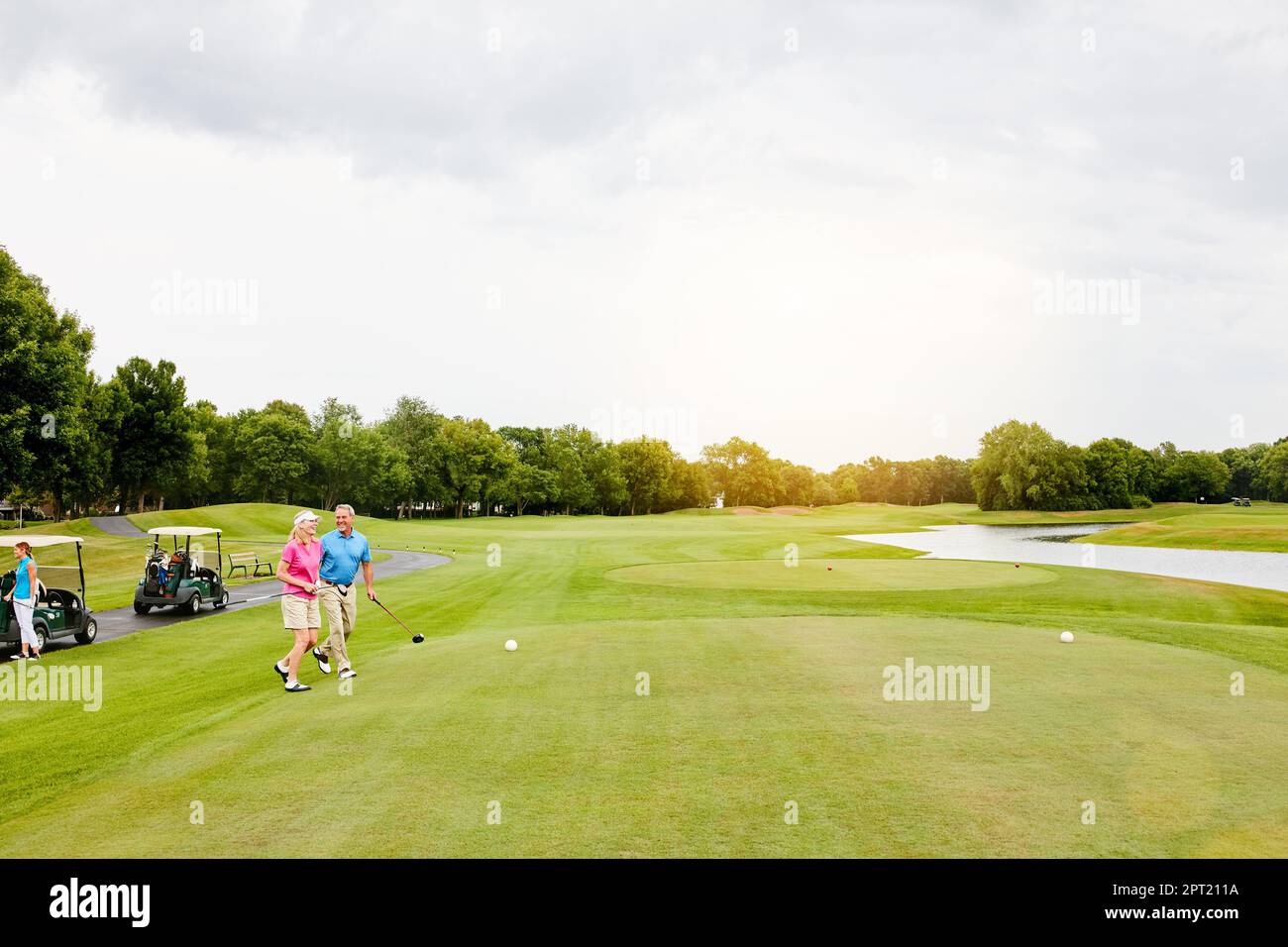 Were ready for a game of golf. a mature couple out playing golf ...