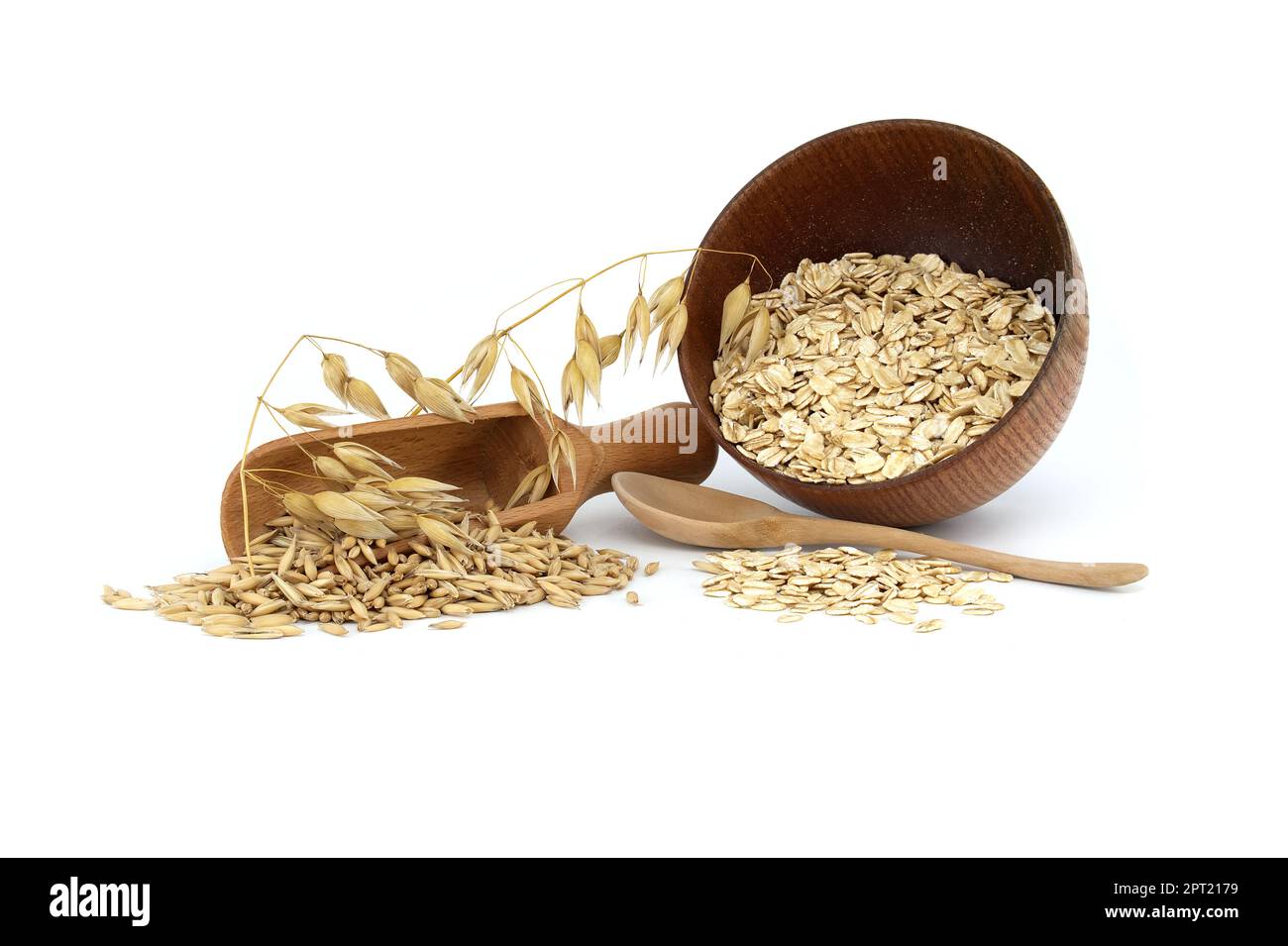 Oat grains with hulls or husks in wooden scoop and oats groats rolled ...