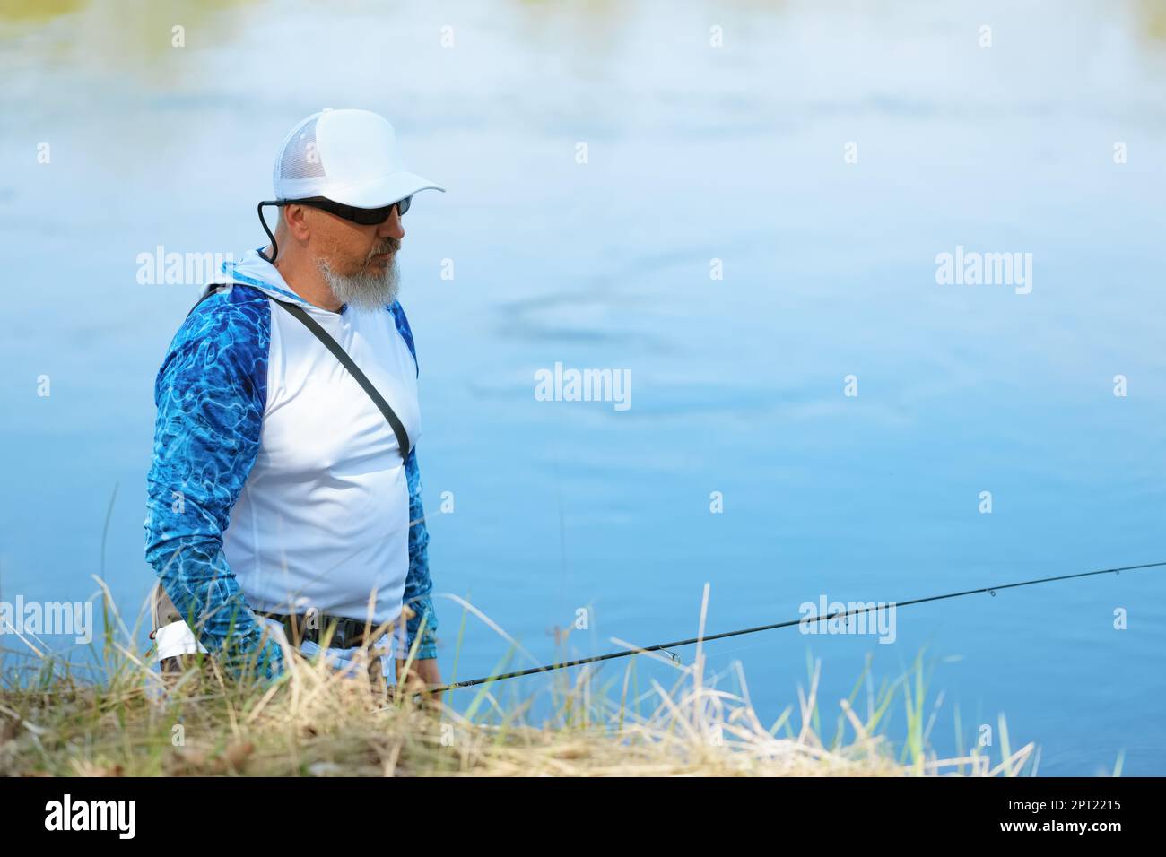 Fisherman trying to do a perfect cast, throwing lure. Spining fishing ...