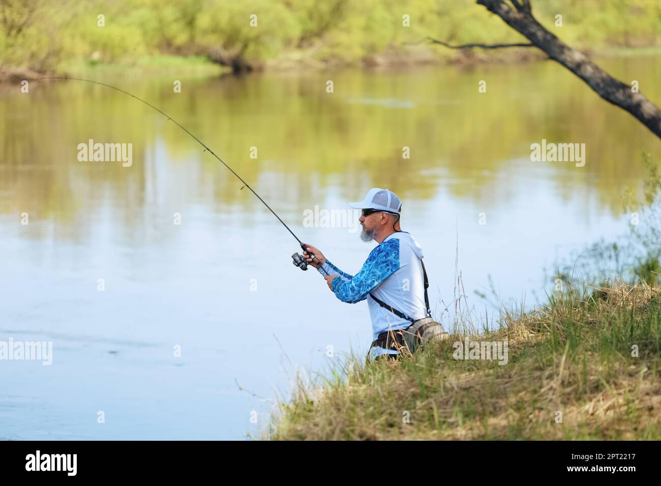 Fisherman trying to do a perfect cast, throwing lure. Spining fishing ...