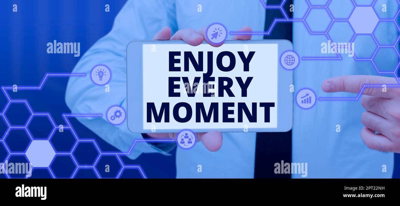 Hand writing sign Enjoy Every Moment, Business concept stay positive ...