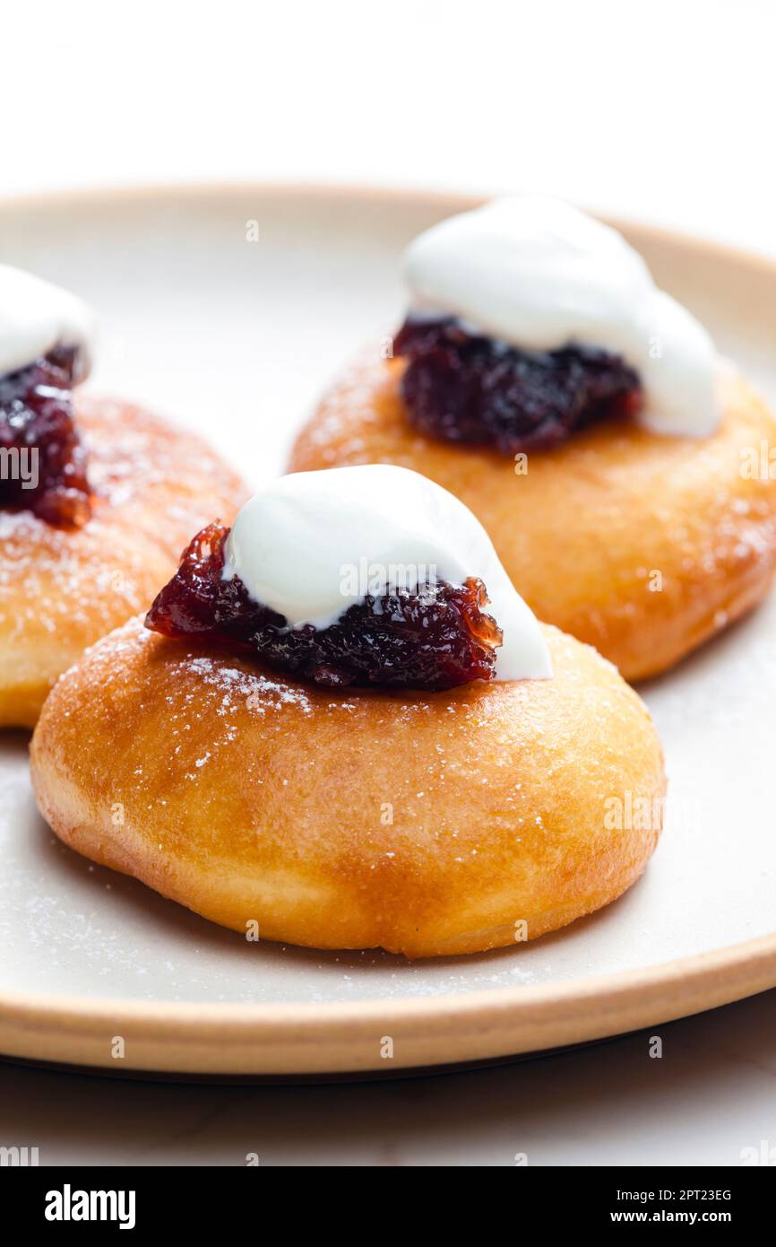 fried muffins with plum jam and sour cream Stock Photo - Alamy