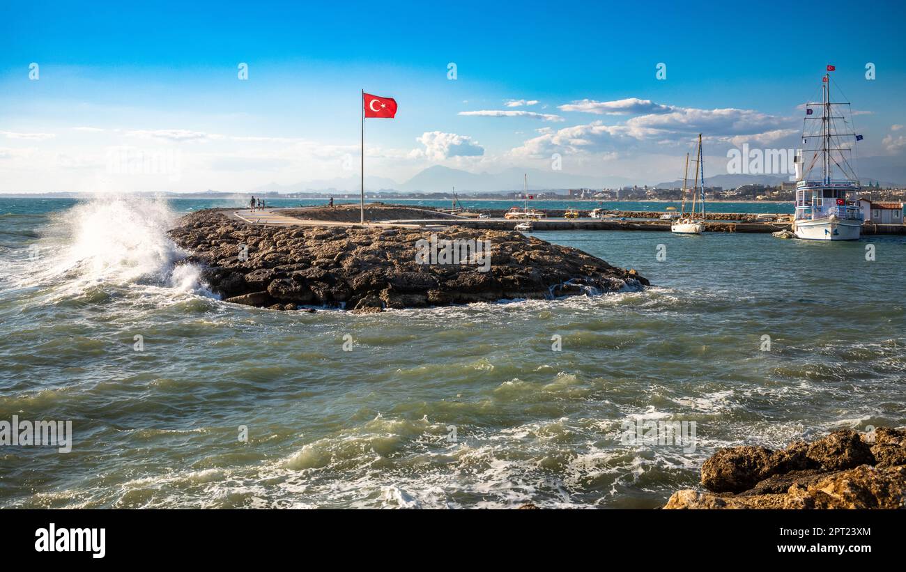 The Turkish flag flies at the end of a breakwater, or harbour wall ...