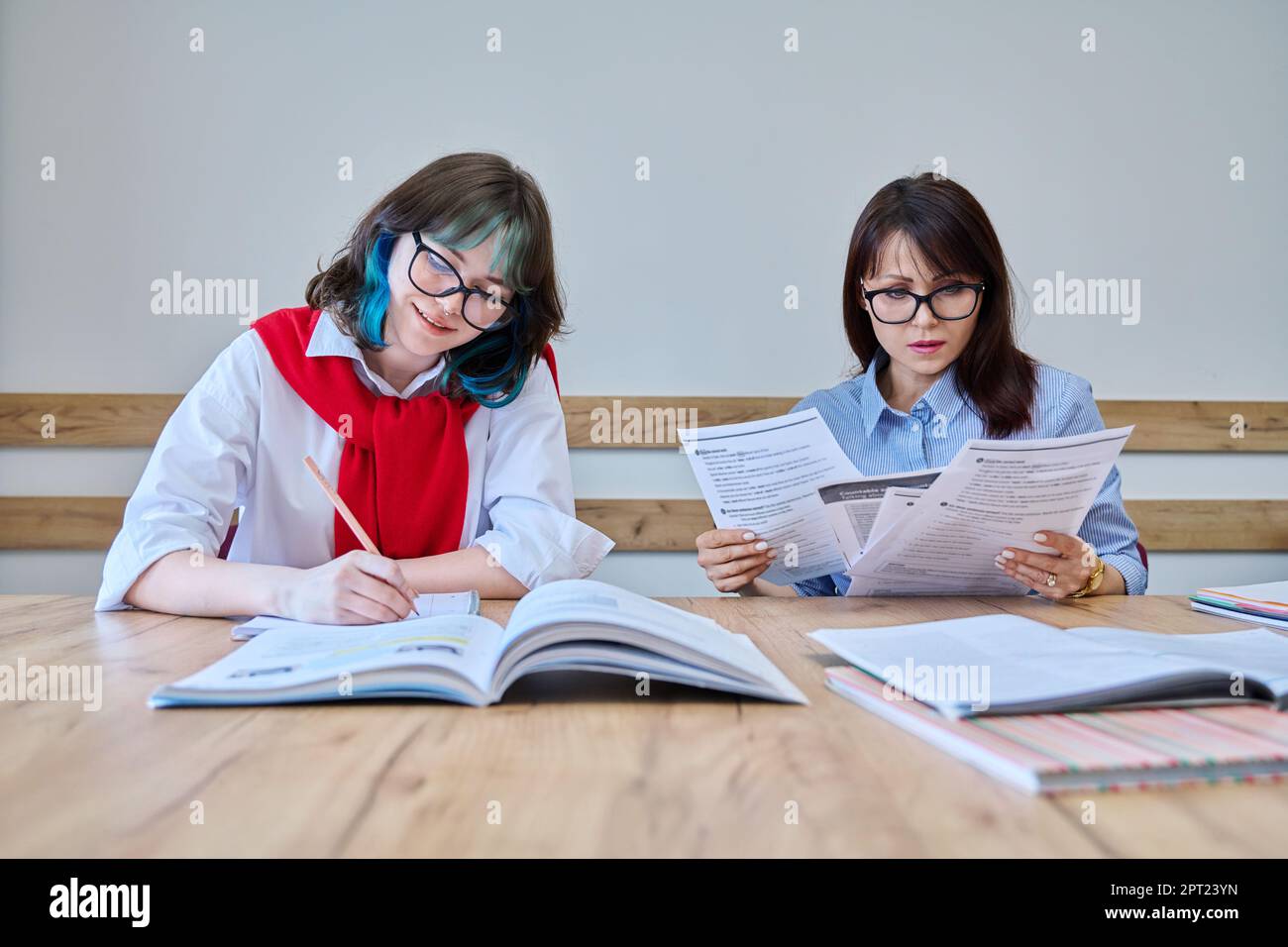 Young teenage female studying foreign languages in course with teacher ...