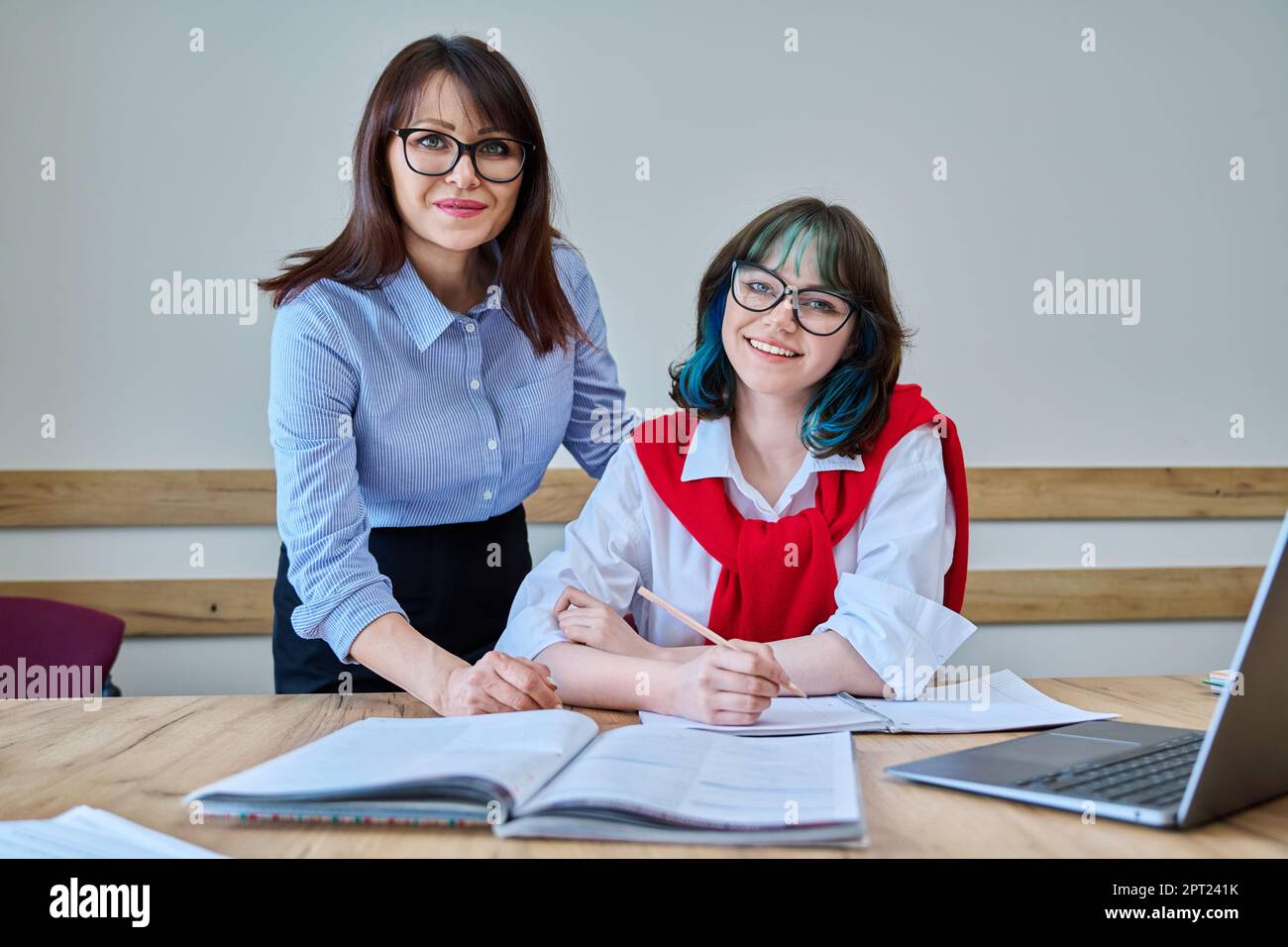Young teenage female studying languages with teacher in classroom Stock ...