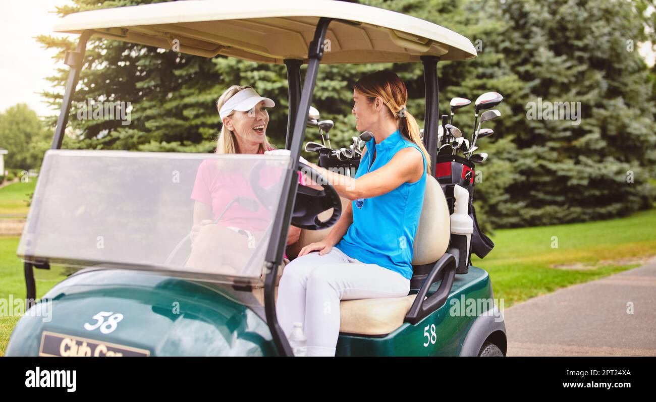 Lets get going. an attractive young woman and her mother driving a golf ...