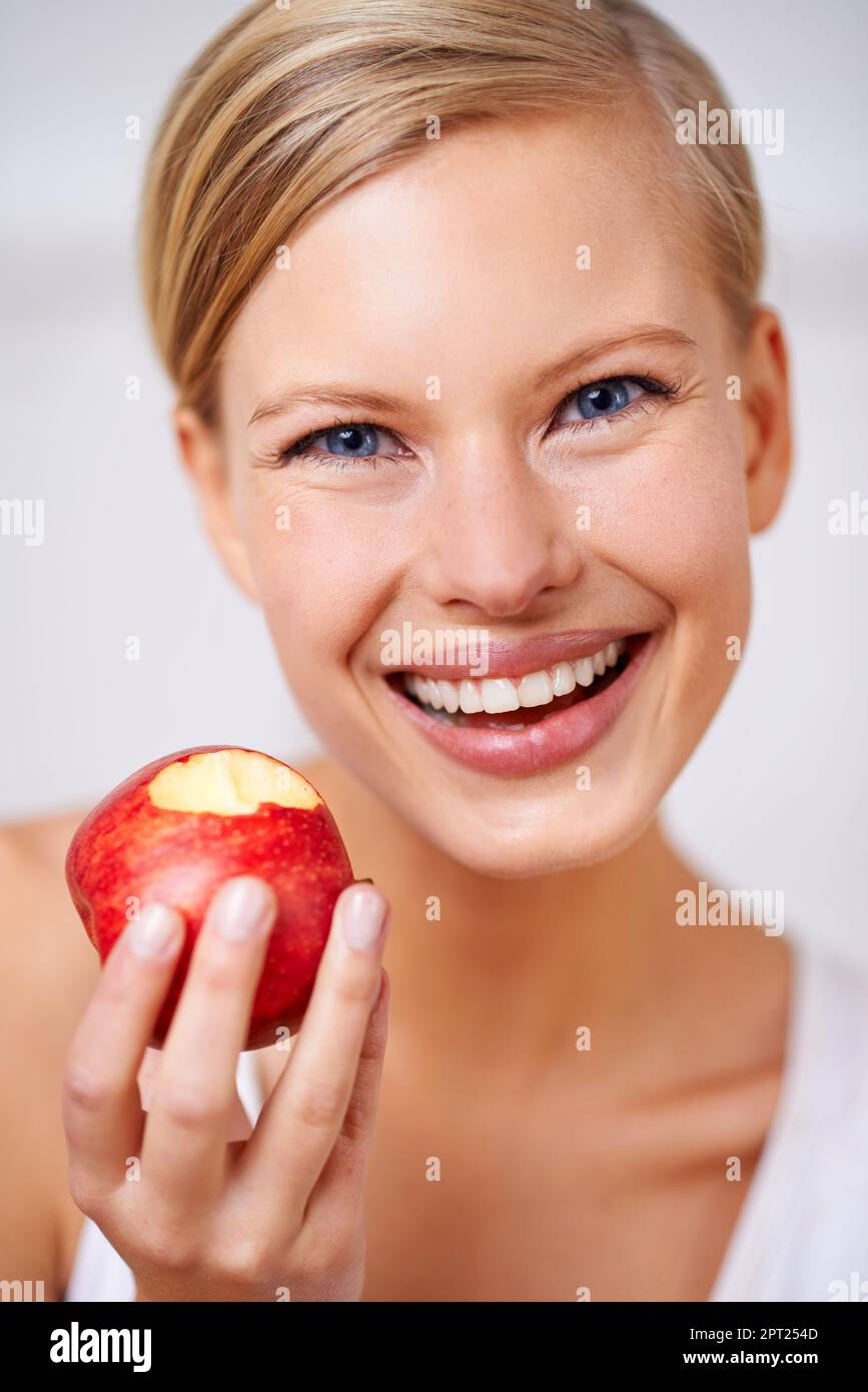 An apple a day is the healthy way. A portrait of a beautiful young ...
