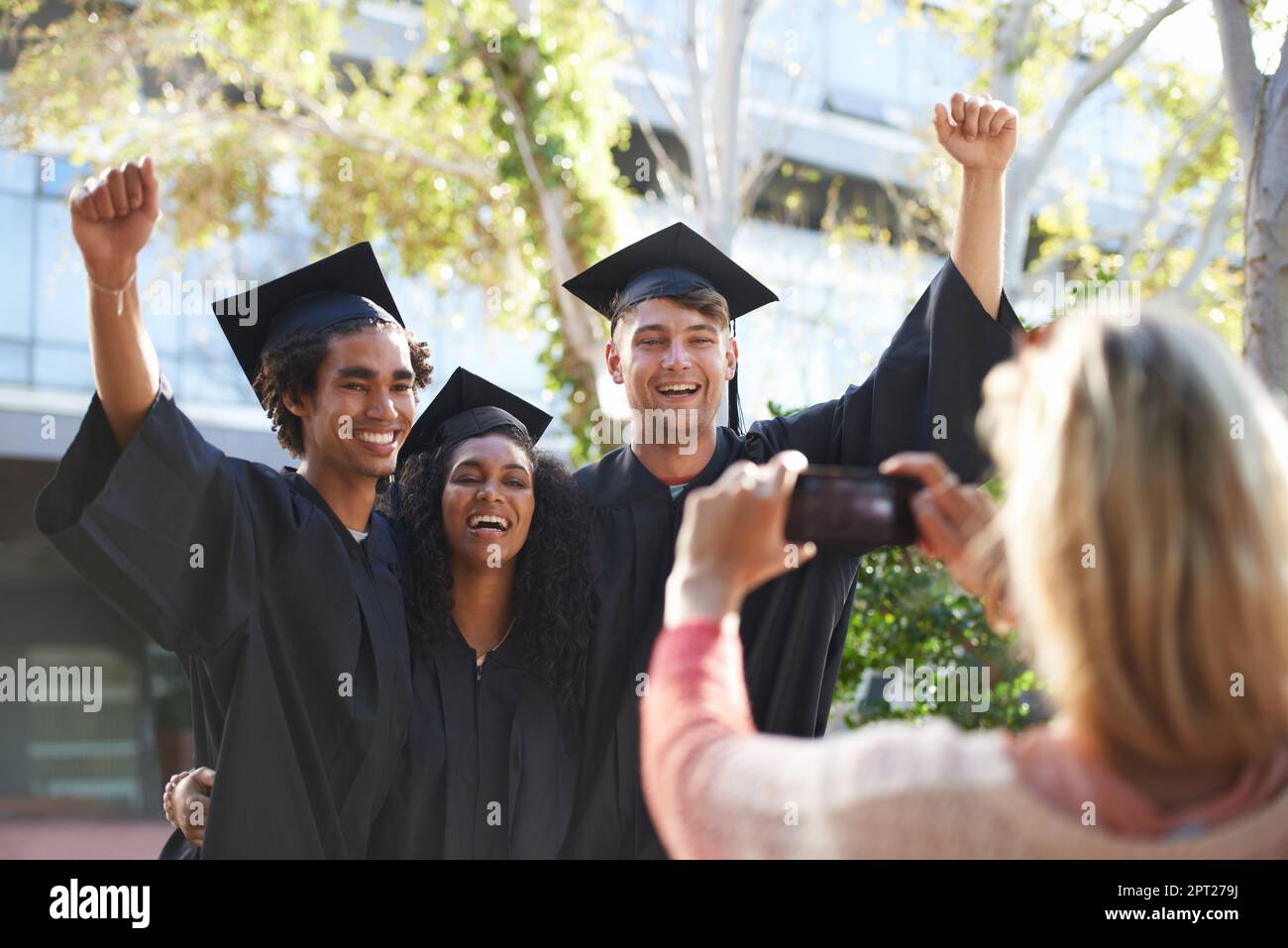 We made it. A mother taking a shot of a group of happy college ...