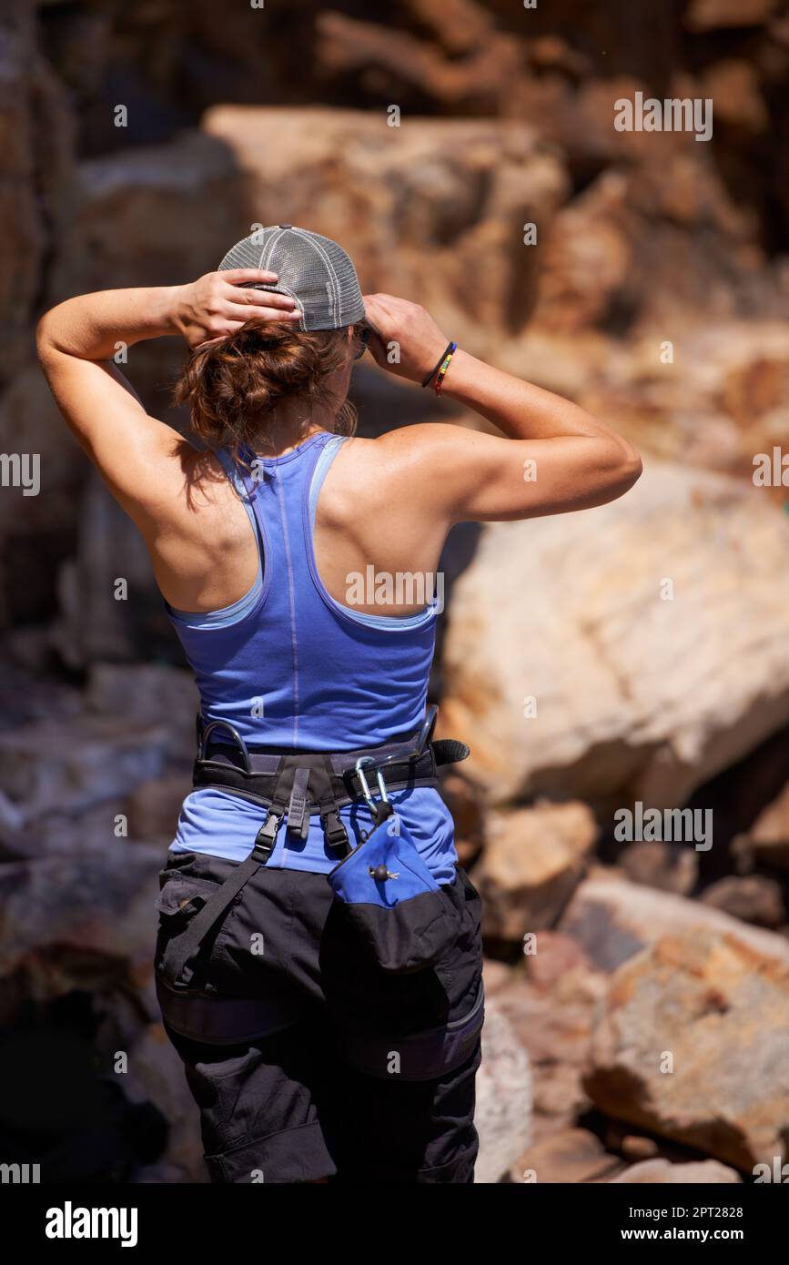 This is quite a daunting climb. a young woman staring up the rock face ...
