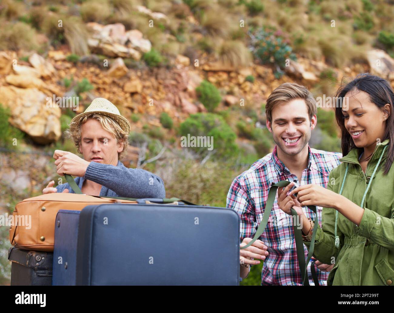 Teamwork makes it go faster. A group of young people unloading their ...