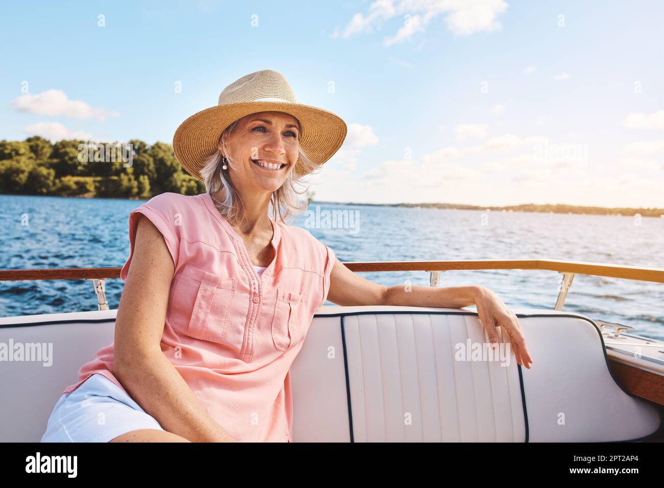 The ocean is her happy place. a mature woman enjoying a relaxing boat ...