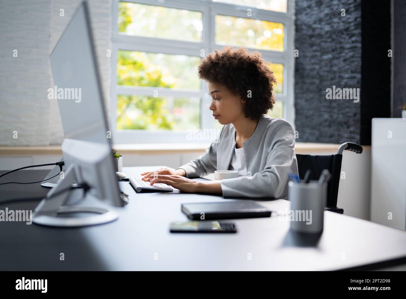 African American Black Woman Using Computer. Worker With Disability ...