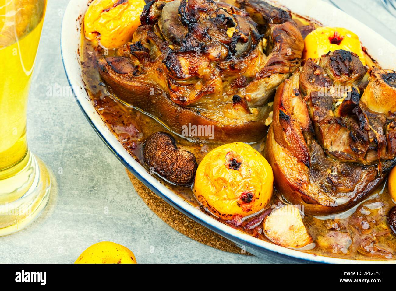 Roasted pork knuckle eisbein with cabbage and apples. Pork leg, German ...