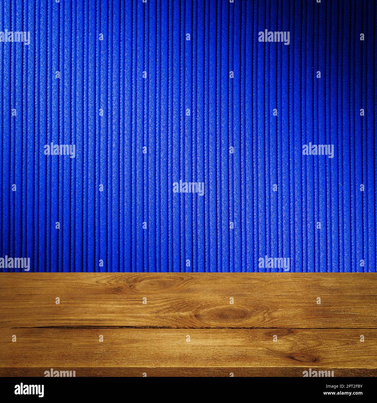 The background is blank wooden boards and a textured striped wall with ...