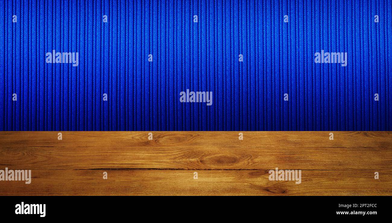 The background is blank wooden boards and a textured striped wall with ...