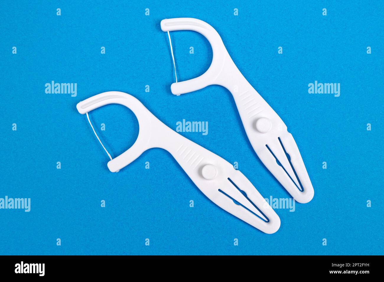 Floss Picks on blue background.Dental hygiene concept Stock Photo - Alamy