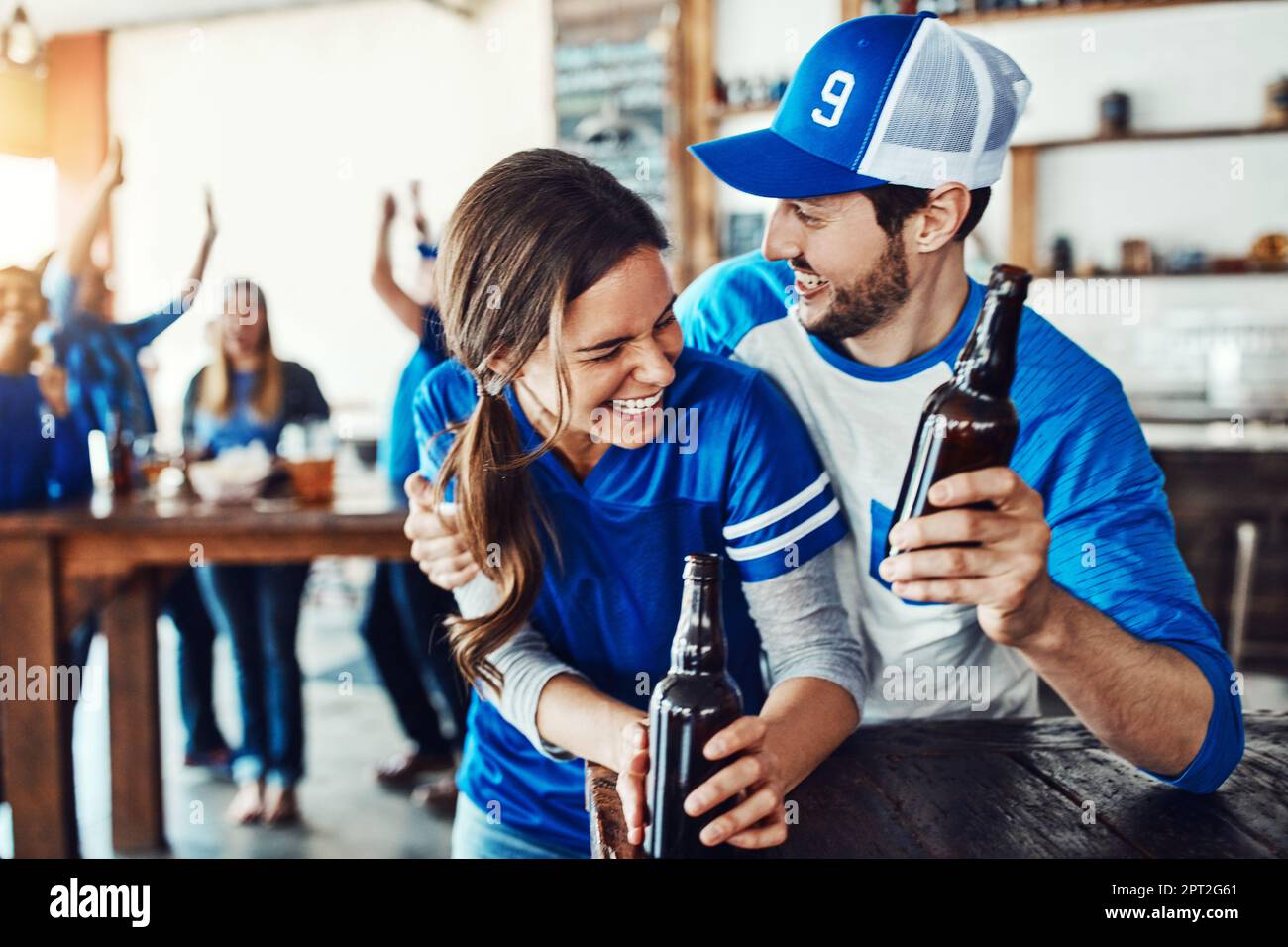 If She Supports Your Team Shes A Keeper A Young Couple Having Beer