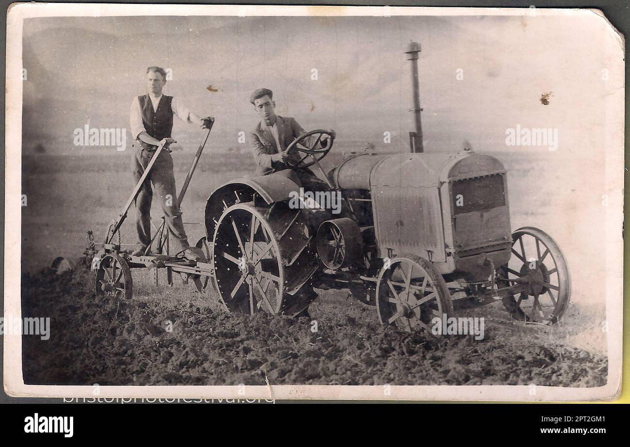 Two men ploughing a field with a tractor (1932 Stock Photo - Alamy
