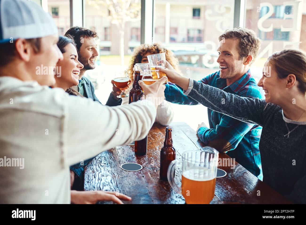 Thanks for coming out guys. a group of happy friends toasting with ...