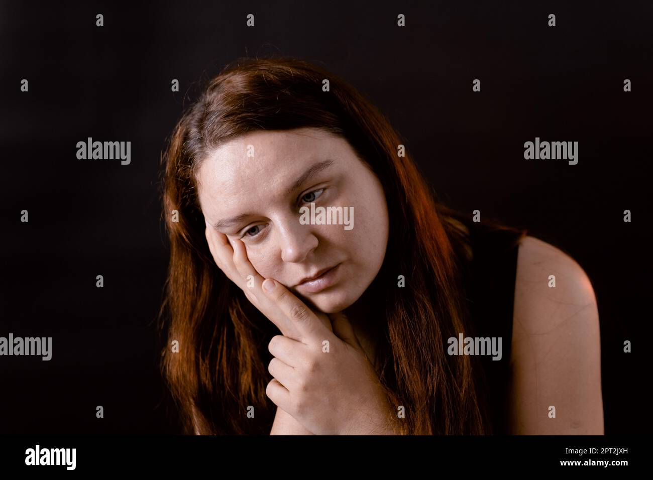 Sad woman concerned with life problems putting head on hand. Upset ...