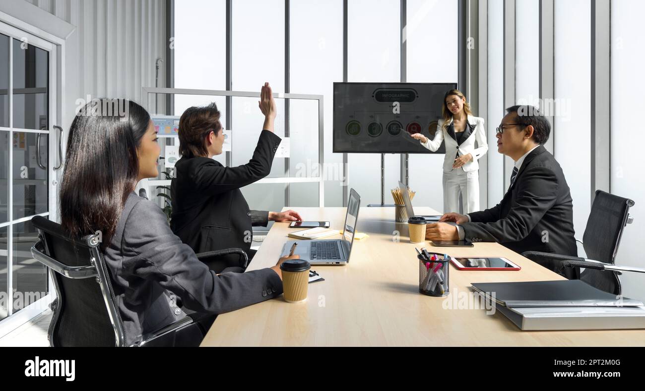 Young asian businessman in suit raise his hand to ask a question to ...