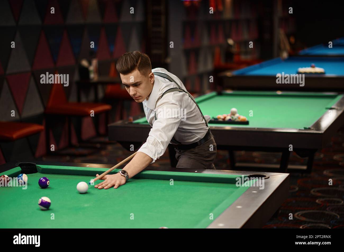 Man playing billiards, focus on serious concentrated face of pool ...
