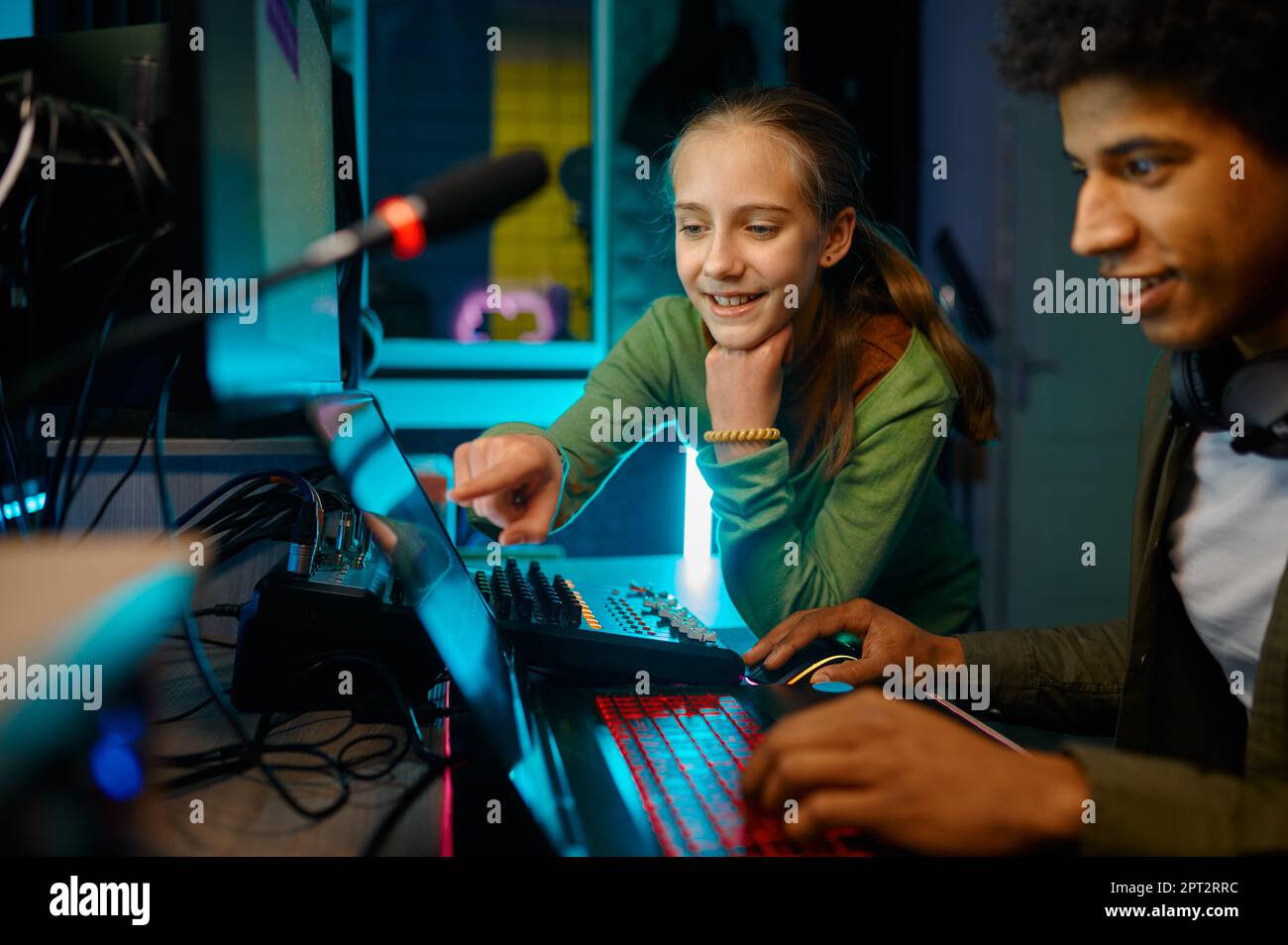 Sound producer mixing track with a child in recording studio Stock ...