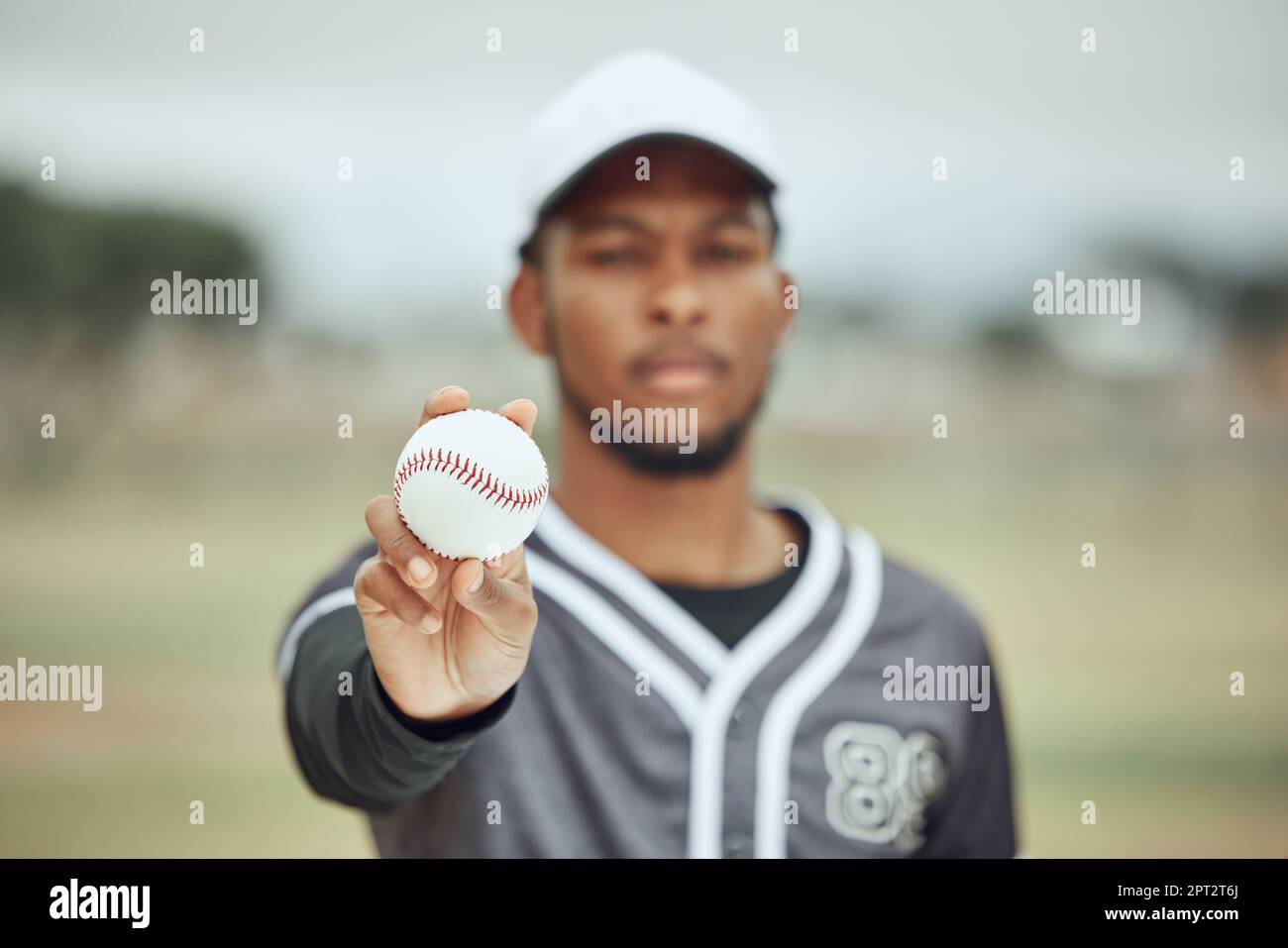 Baseball in hand, baseball player and athlete on field training for ...