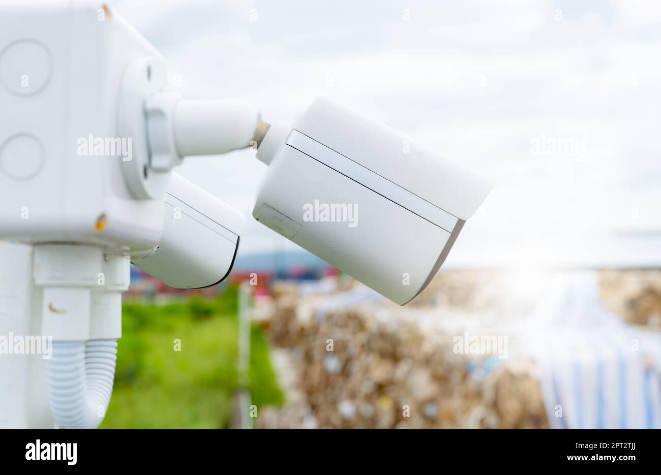 Side view of white CCTV security camera video system for safety at a ...