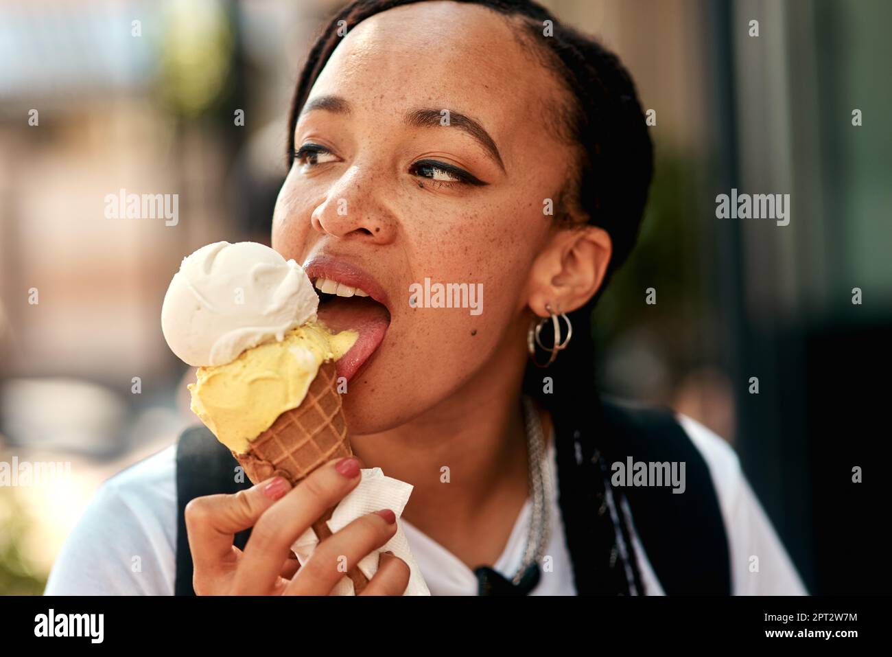 Ice cream made me do it. a young woman enjoying a ice cream cone ...