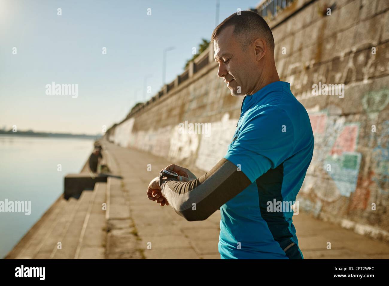 Runner checking smartwatch controlling pulsations after exercise. Sport ...