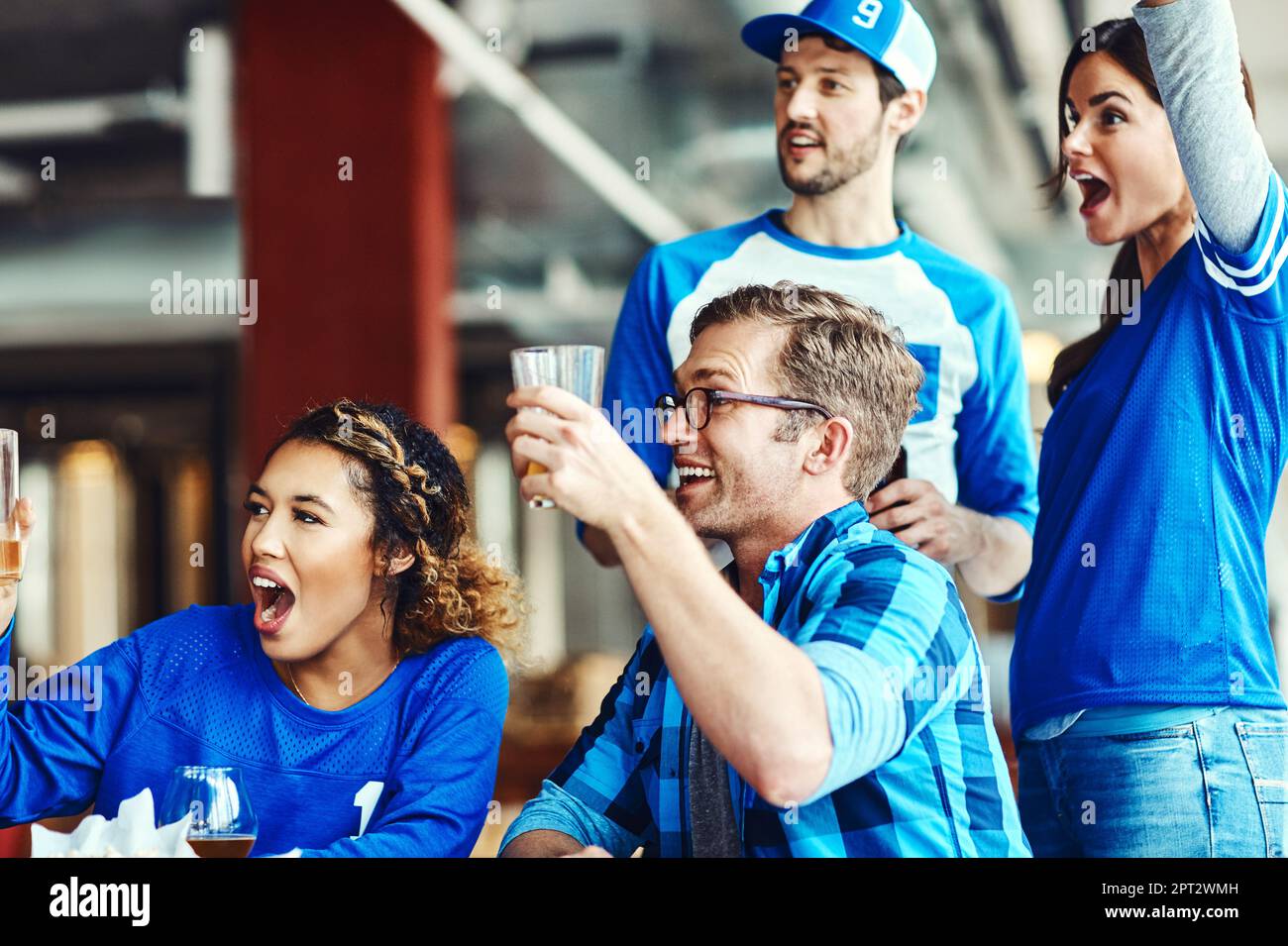 Their team keeps on raising the score. a group of friends cheering ...