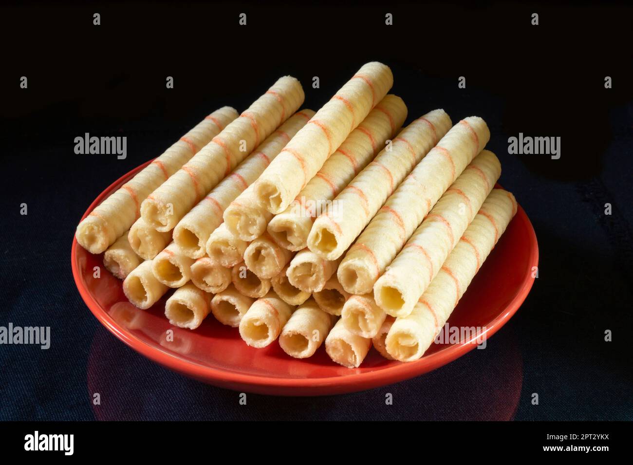 The Sweet sticks with stuffing in red plate on black background ...
