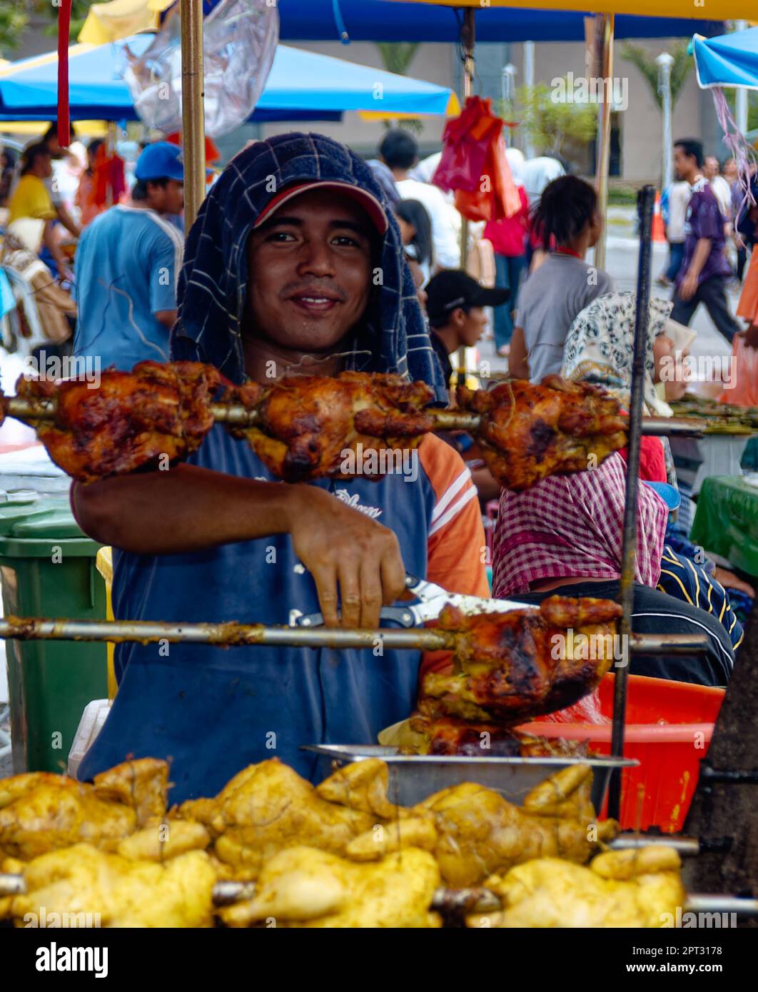 Hawker stall producing chicken dishes for Ramadan at a market near ...
