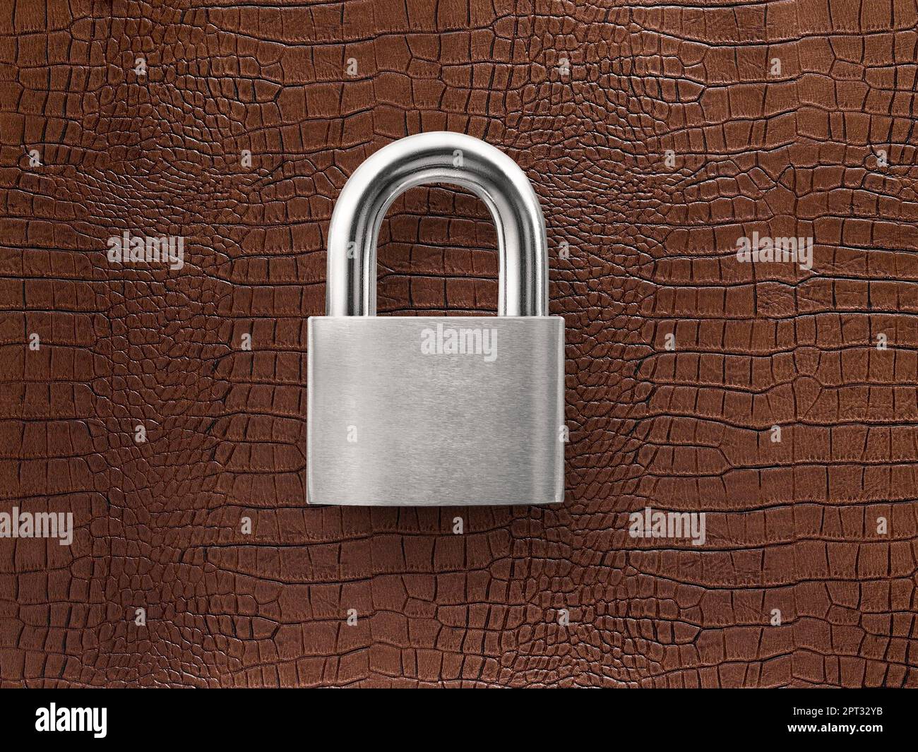 silver closed lock on a brown leather background Stock Photo - Alamy