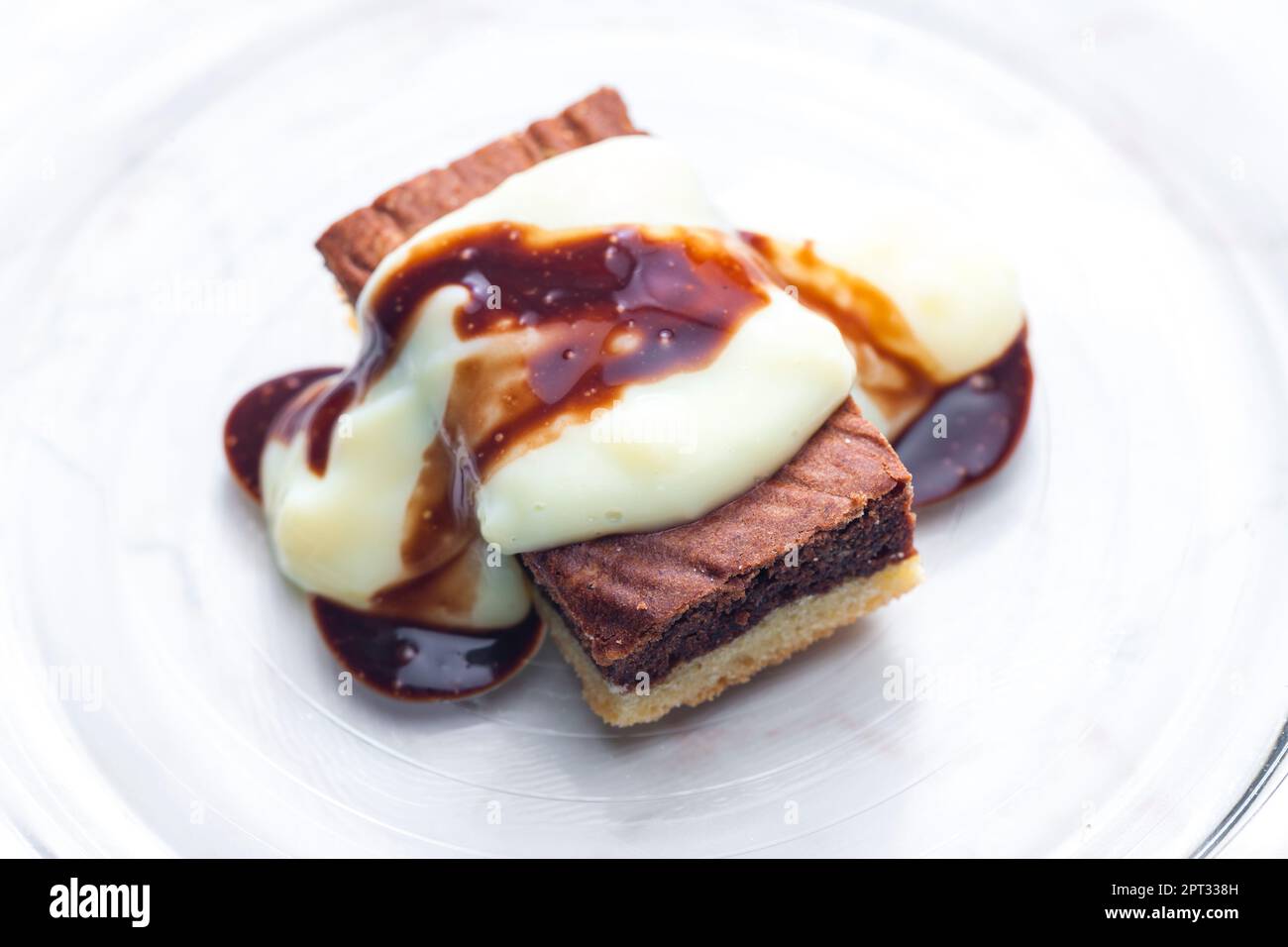 marble sponge cake with creamy custard sauce Stock Photo - Alamy