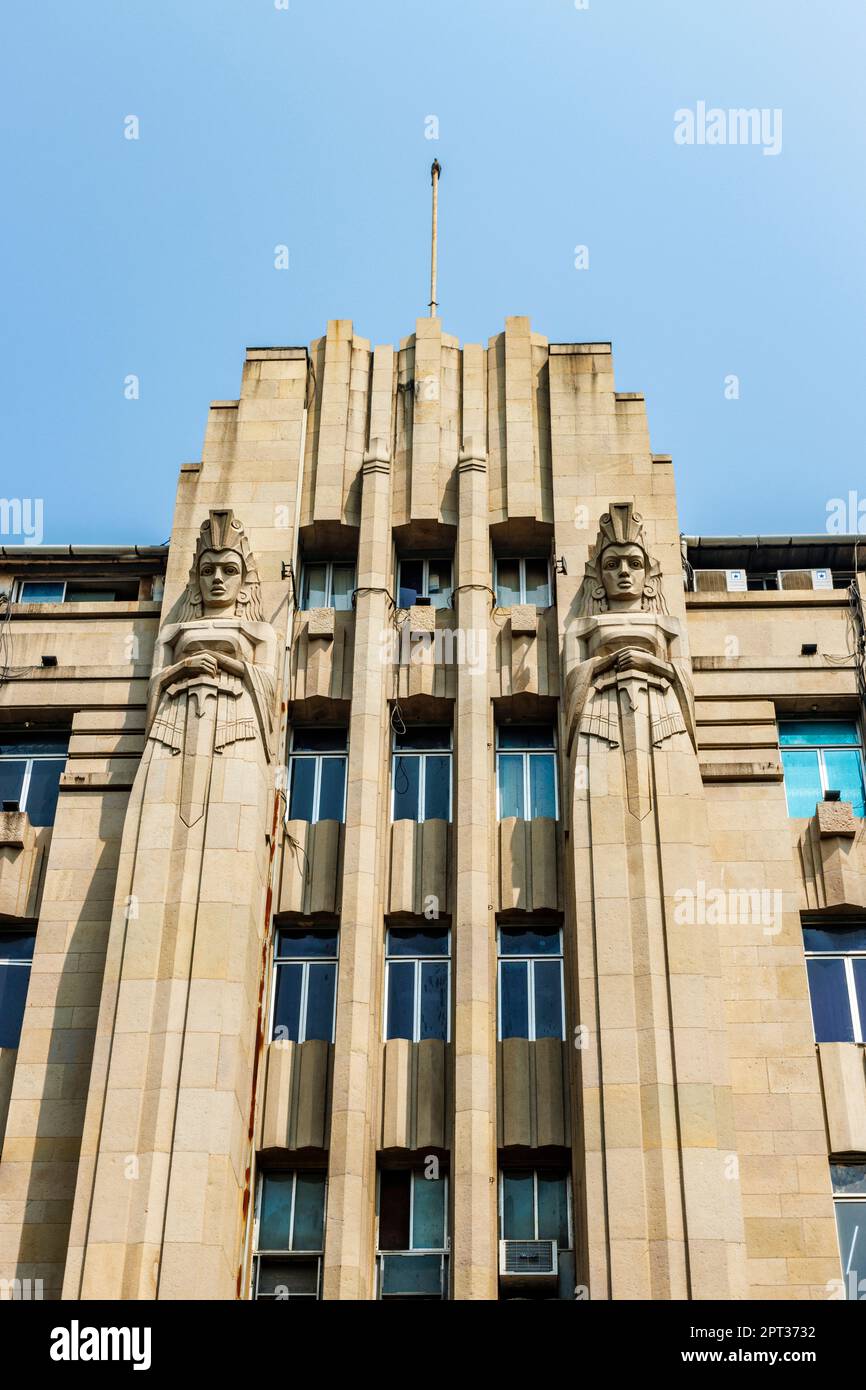 Facade of an art deco building with two female warrior statues on the ...