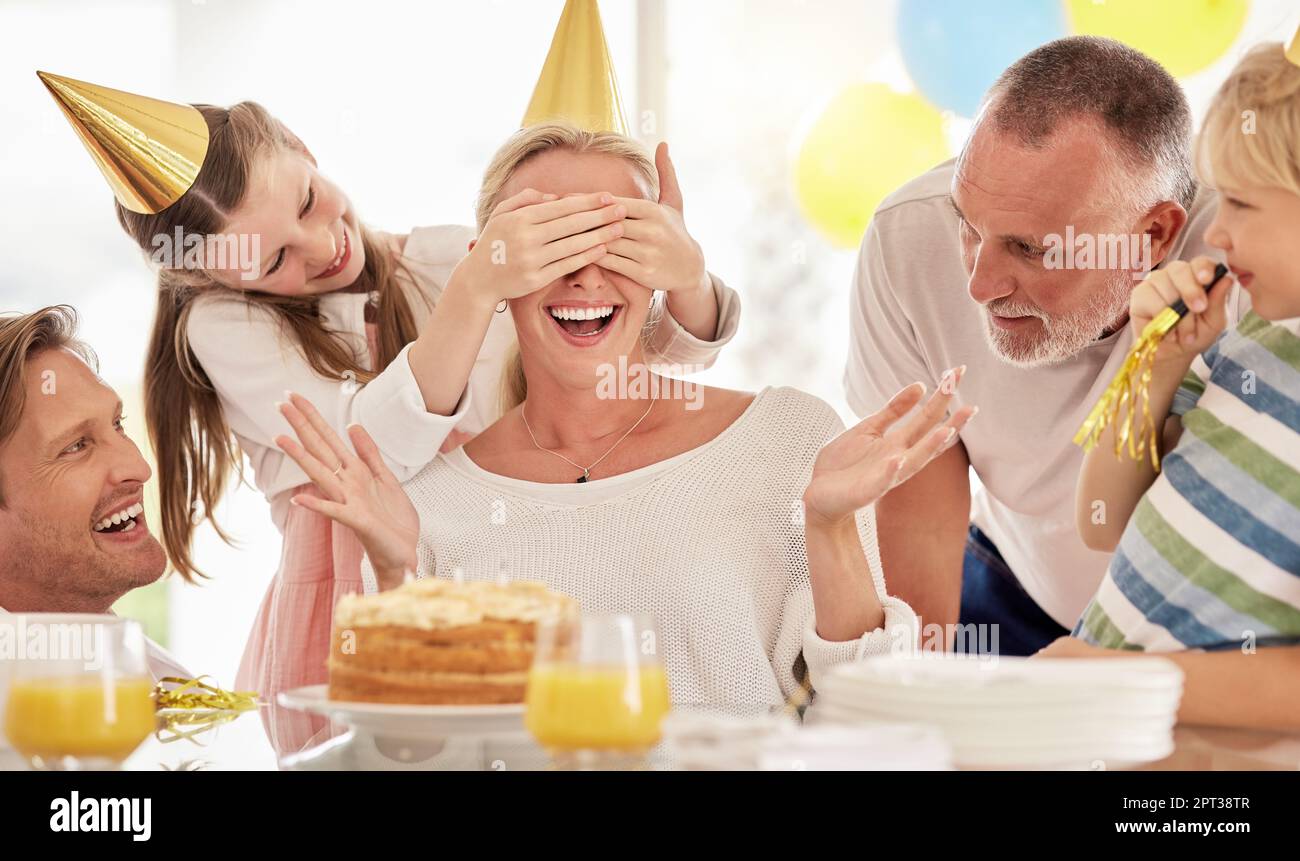 Surprise, birthday cake and mother with family for celebration, party ...