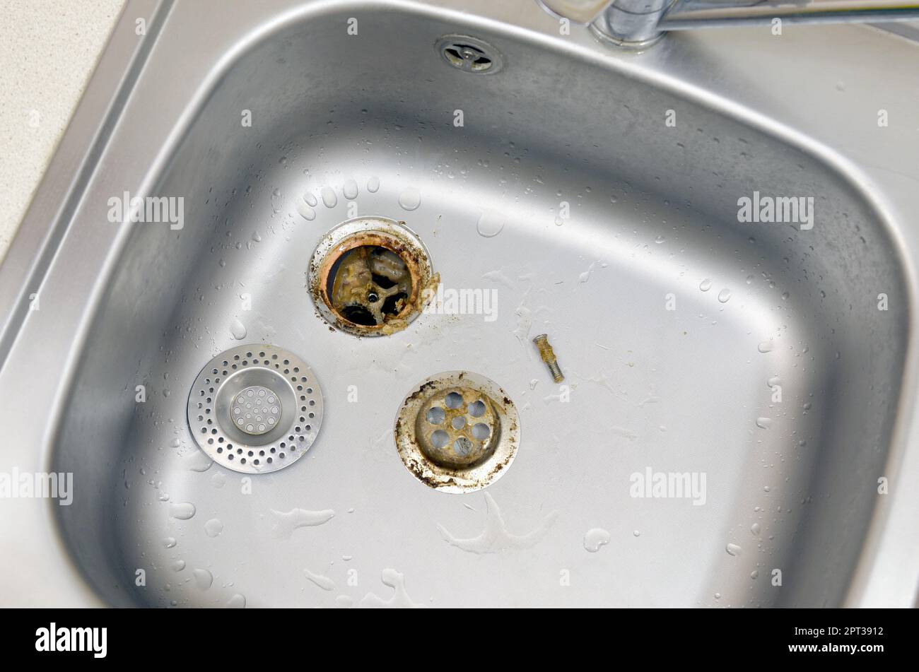 Silvery kitchen sink with a disassembled protective filter. Kitchen ...