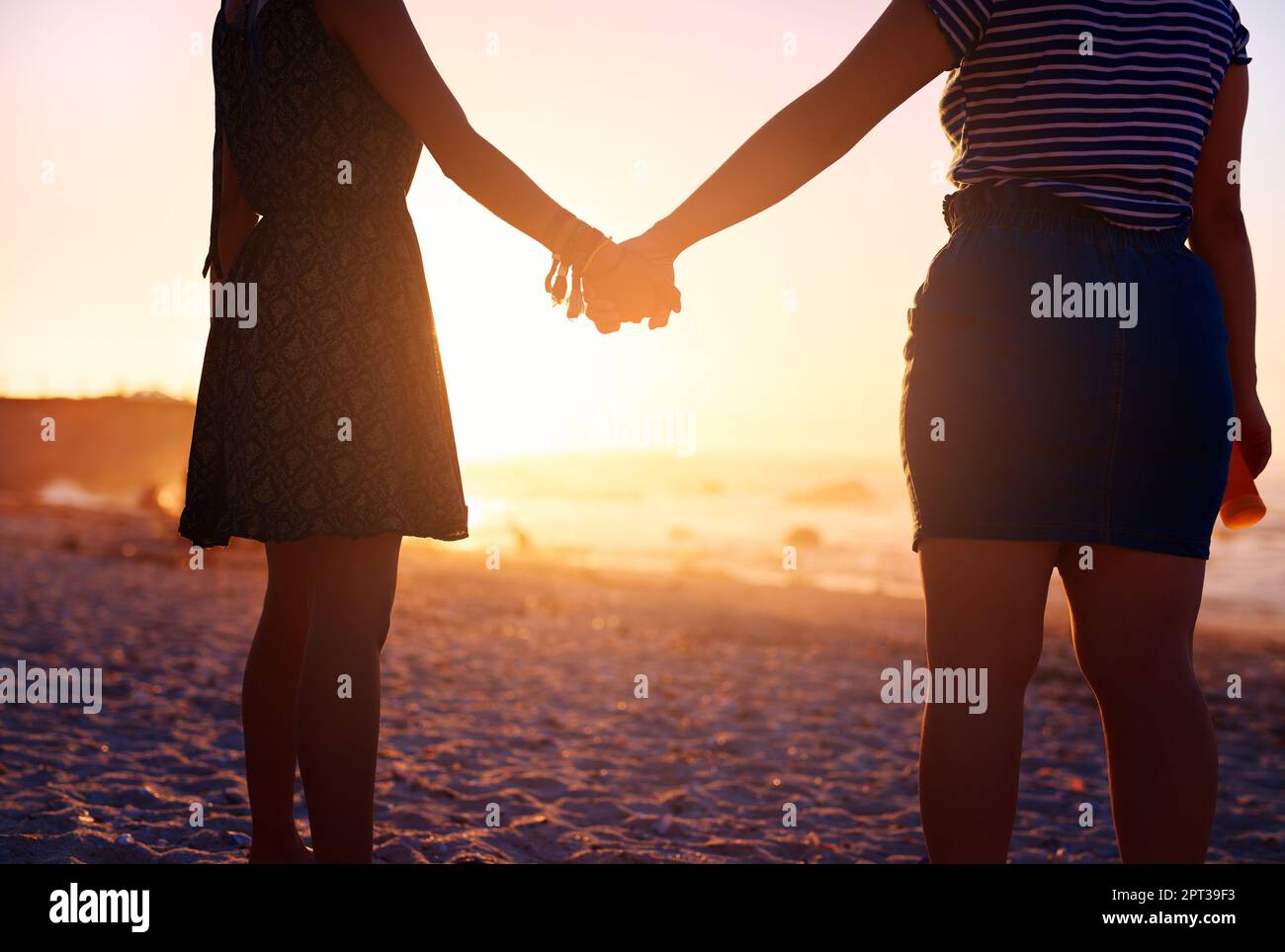 Two Best Friends Holding Hands In The Sunset
