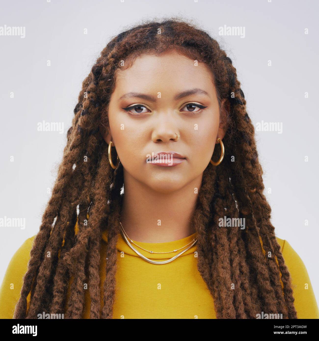 She shows no emotion. Studio portrait of an attractive young woman ...