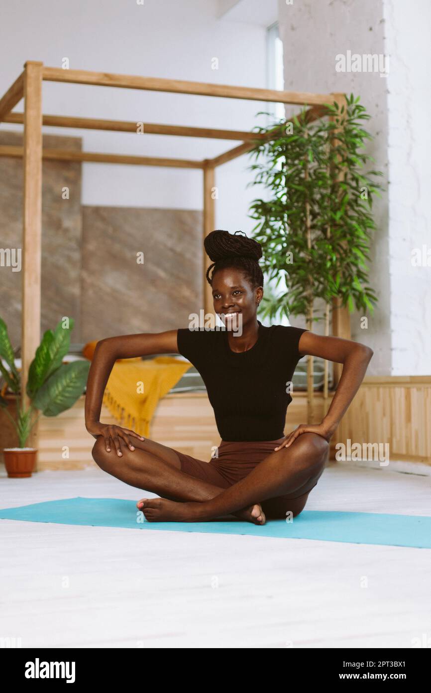 Beautiful And Athletic Afro American Woman Sitting In Butterfly Pose