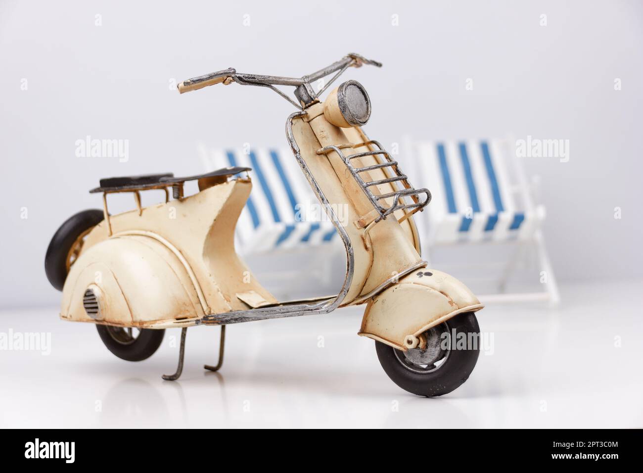 detailed view of motor scooter model on white table with white ...