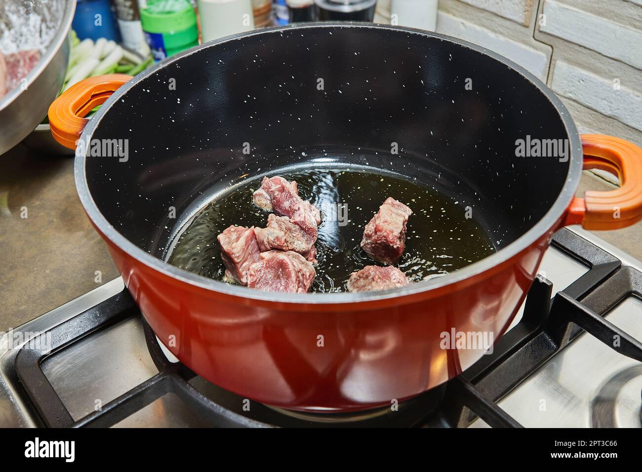 Diced beef meat is cooked in pot on gas stove Stock Photo - Alamy