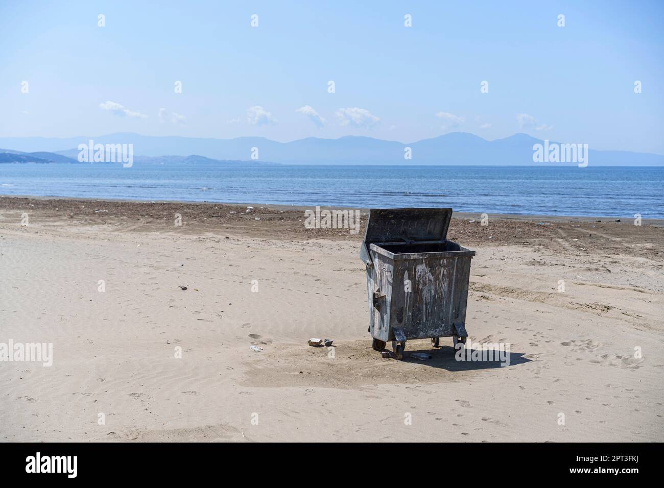 A big metal trash bin on an empty beach Stock Photo - Alamy