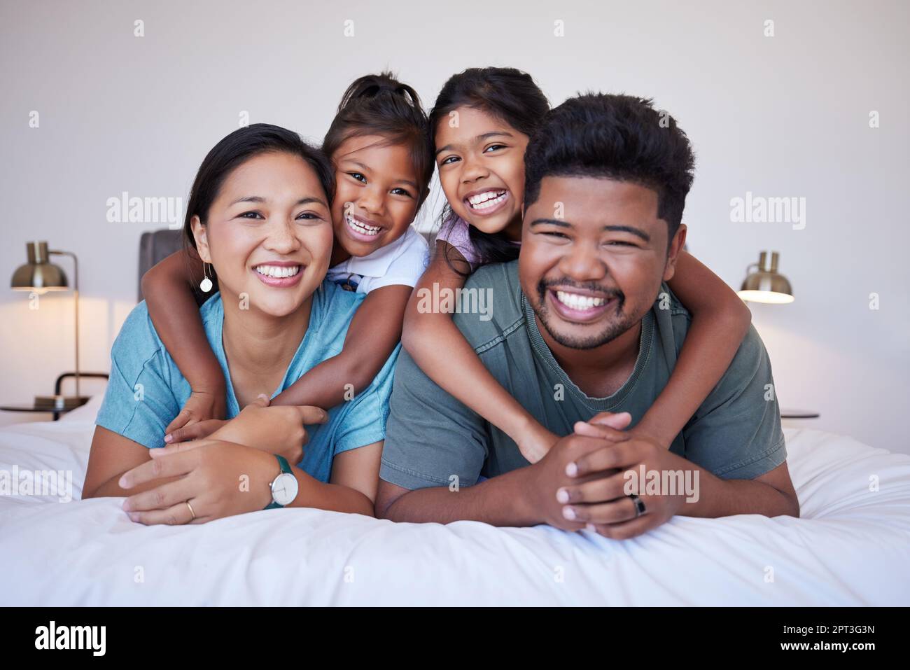 Family, children and smile on bed for happy portrait together in house ...